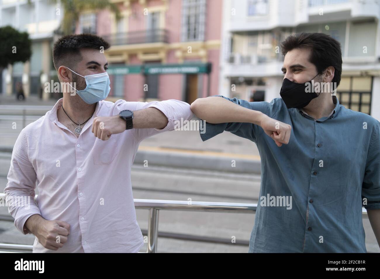 Spanish men wearing masks and greeting each other with elbows - new ...