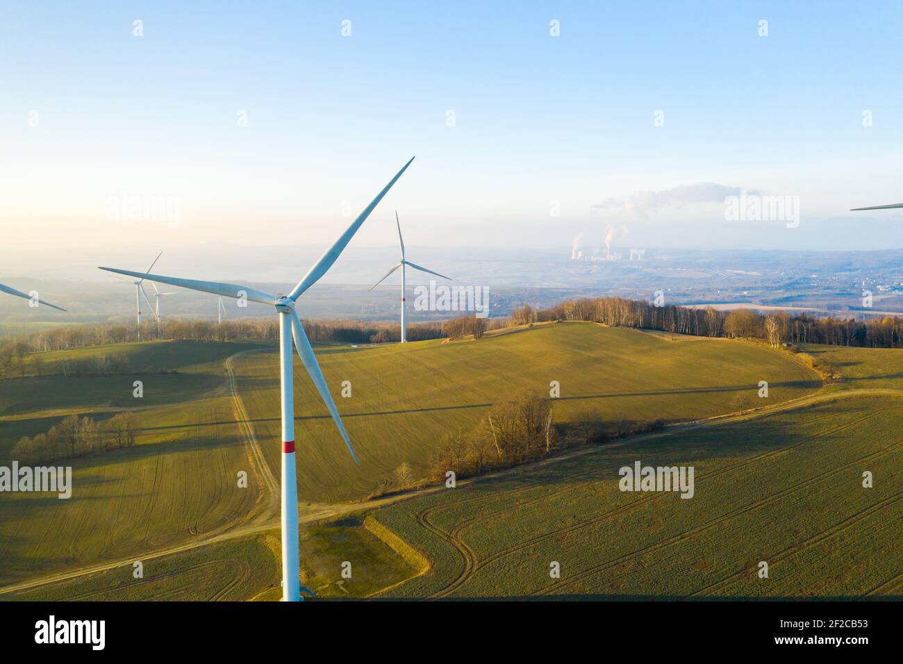 Panoramic view of wind farm or wind park, with high wind turbines for ...