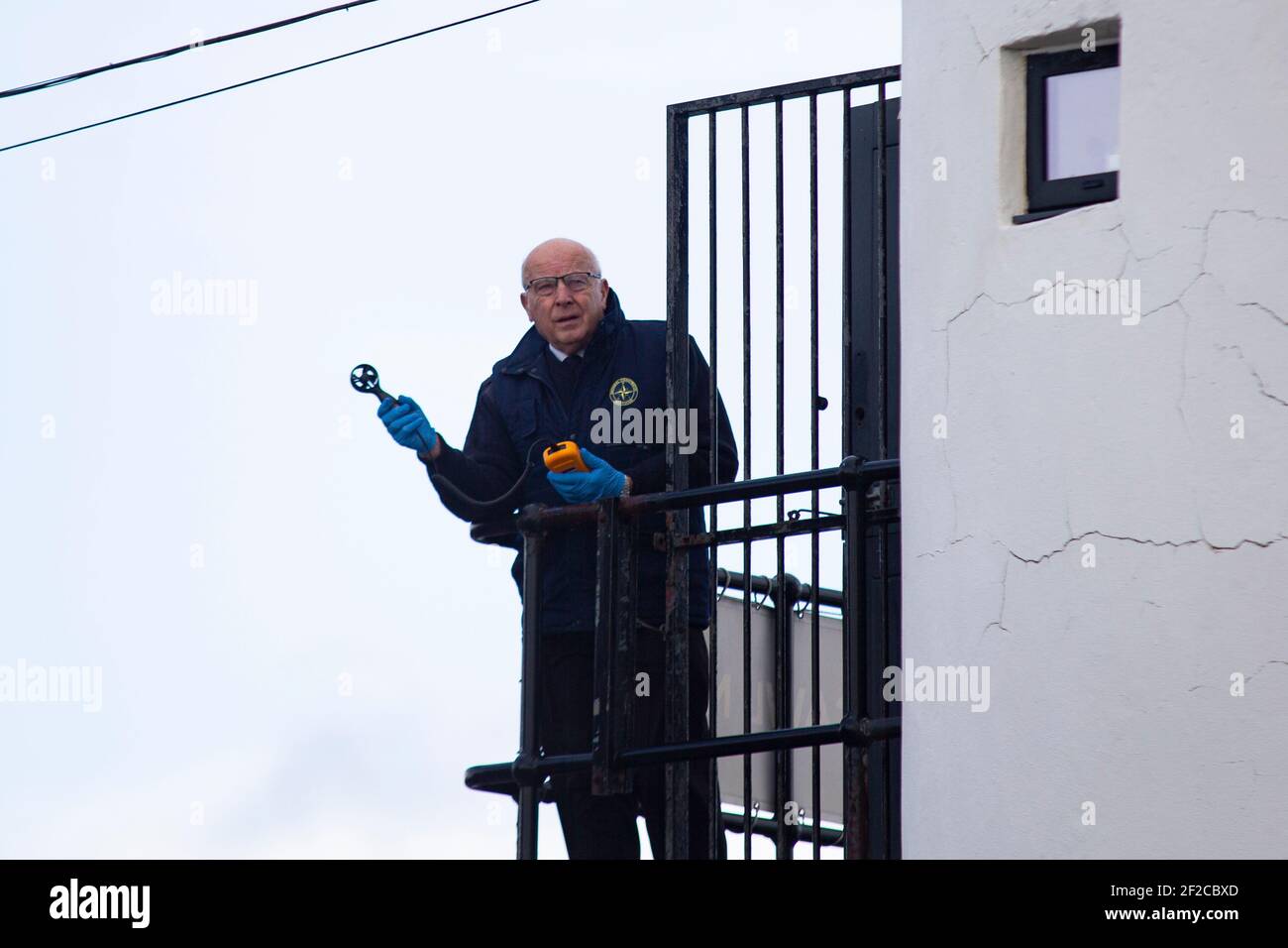 A wind reading is taken at Porthcawl Lighthouse during high tide and ...