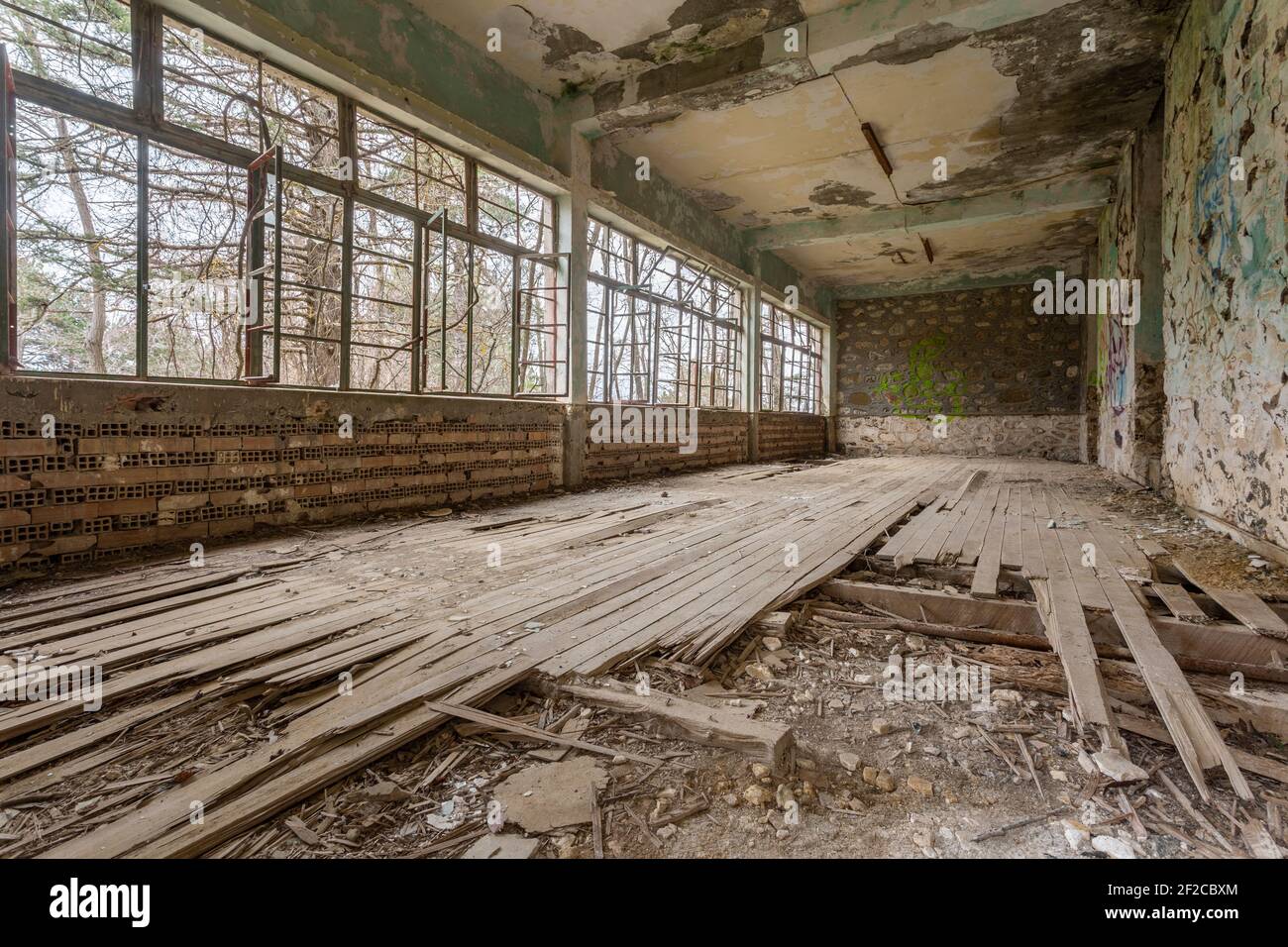 Broken floorboards inside a room of the abandoned Veregaria Hotel, in ...
