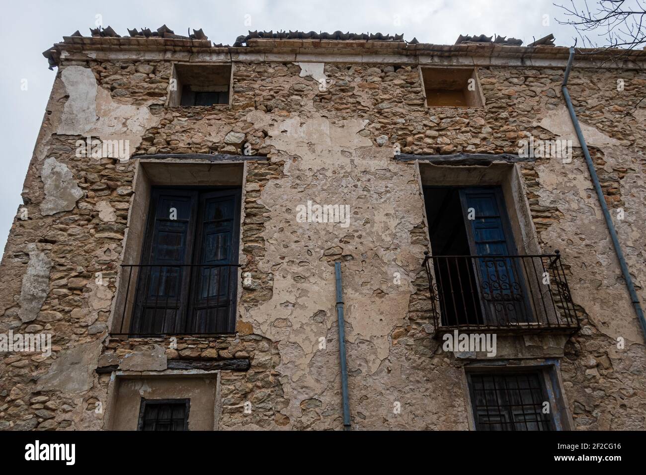 A low angle shot of an old stone building with small balconies Stock ...