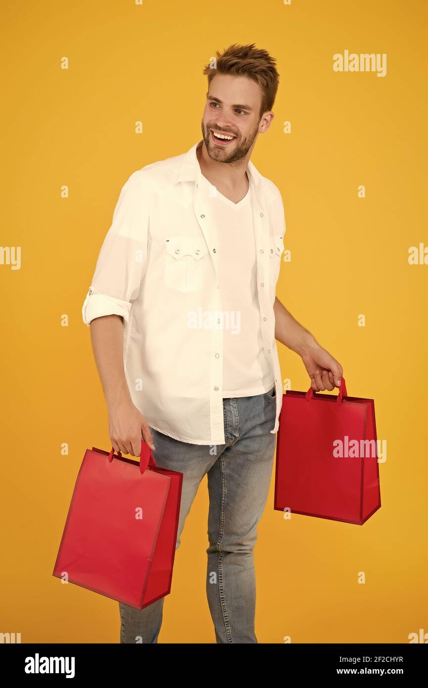 Handsome attractive man smiling while shopping. real shopaholic. buy ...