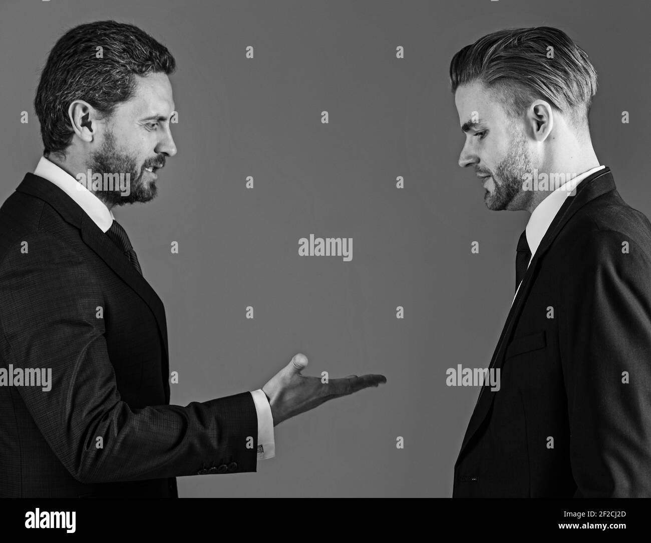 Unshaven businessman with smile raising hand for shaking hands g Stock ...