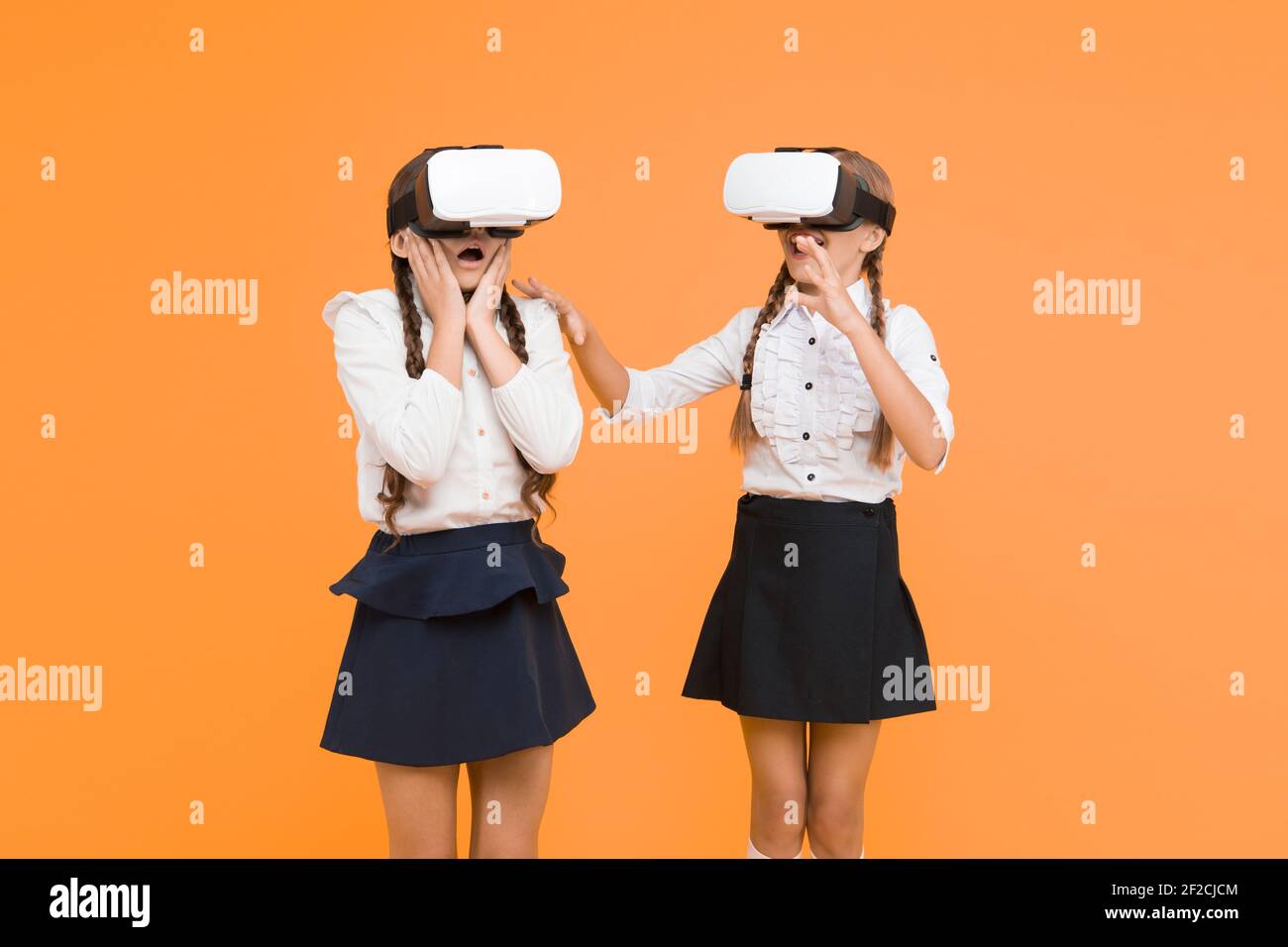 VR headset. Future education. Children schoolgirls wear wireless VR ...