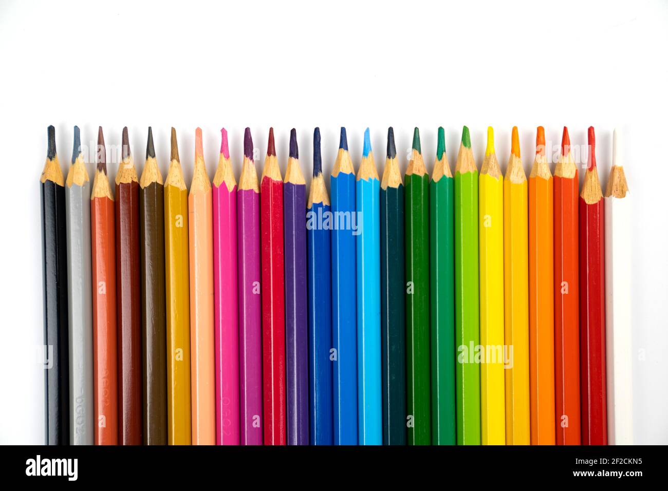 blunt colour pencils are arranged in the line on the white background ...