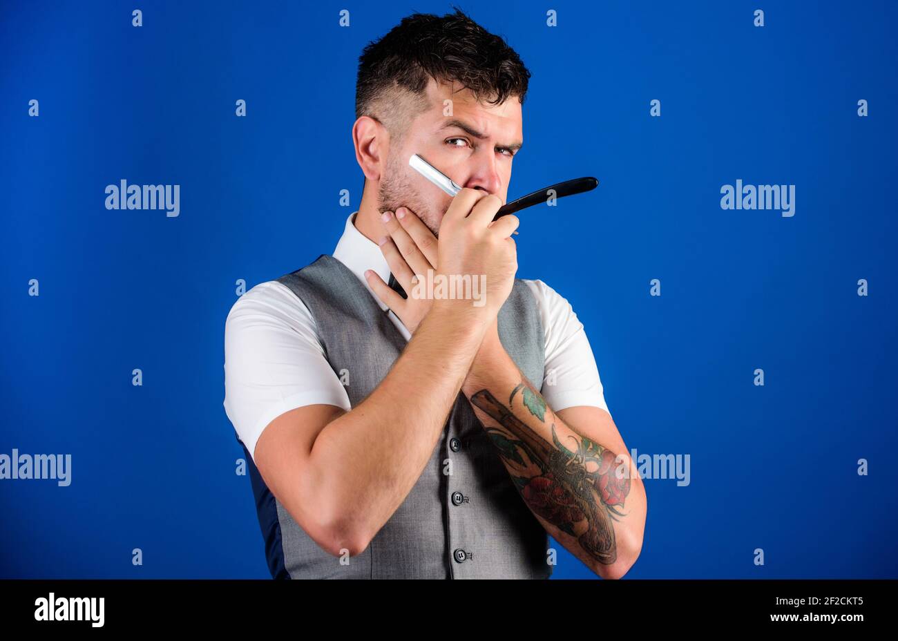 Barber art concept. Barber unshaven hipster with sharp danger straight ...