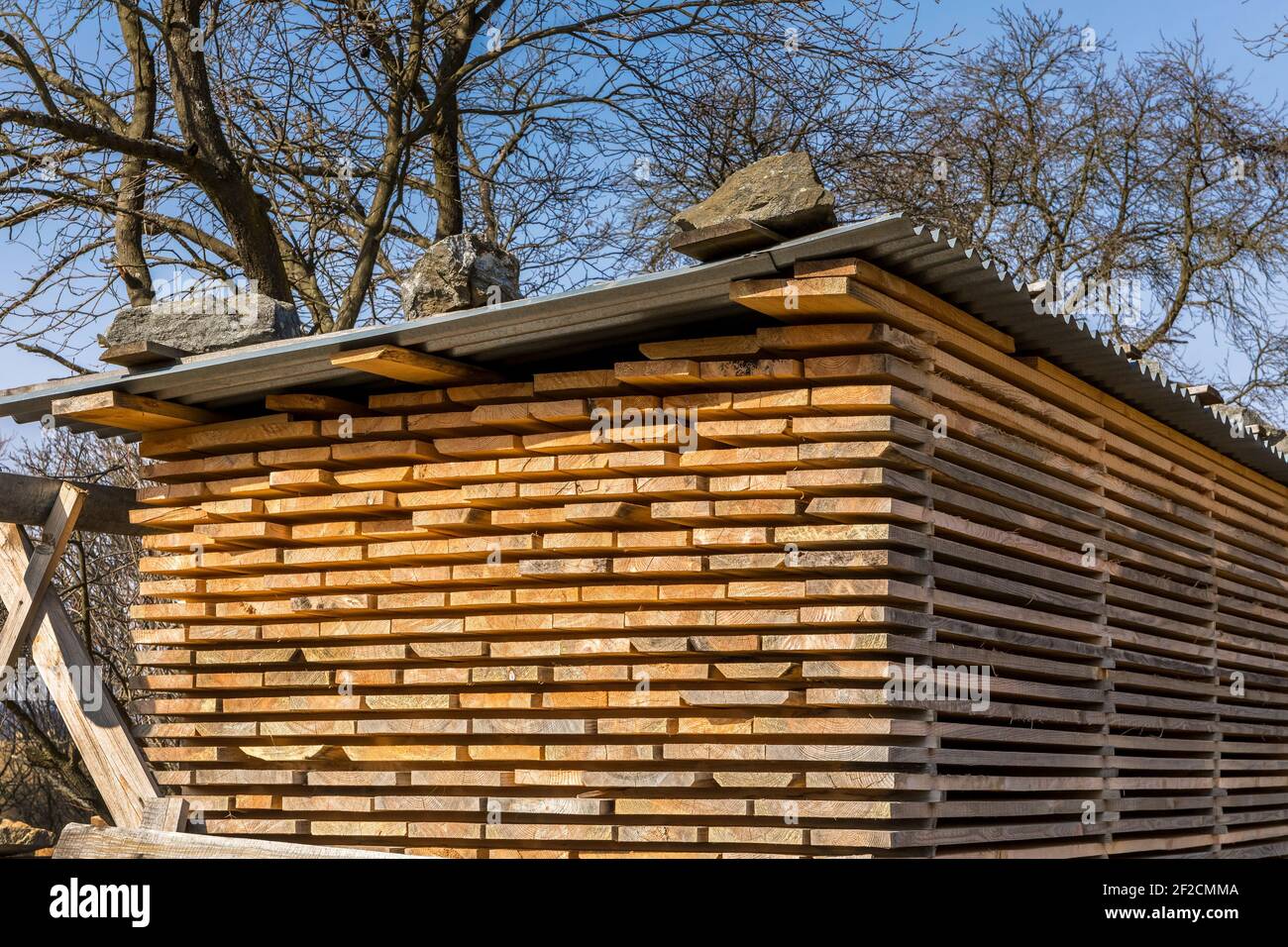 Wooden planks and beams. Air-drying timber stack. Wood air drying. Wood ...