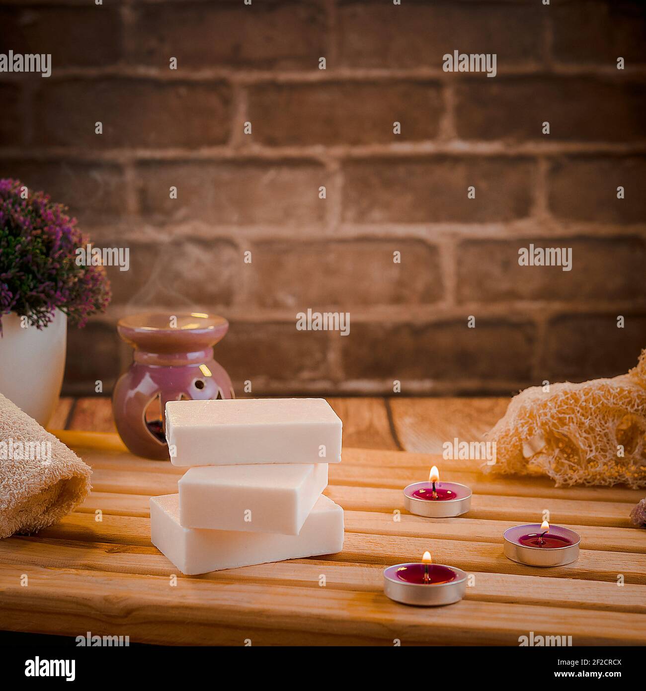 Beautiful spa composition with natural soaps with scented candles and ...