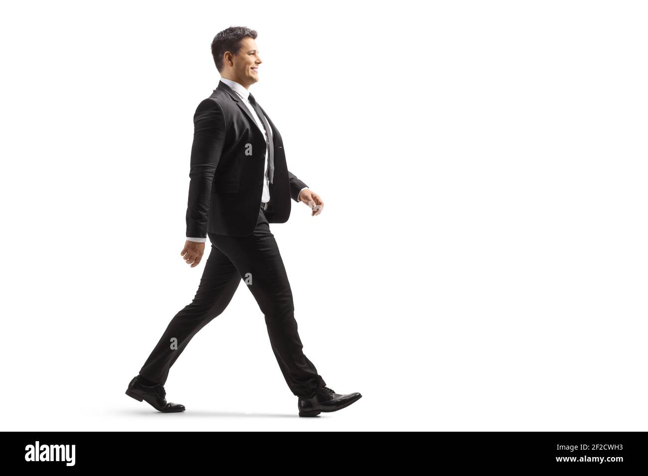Full length profile shot of a businessman walking isolated on white ...