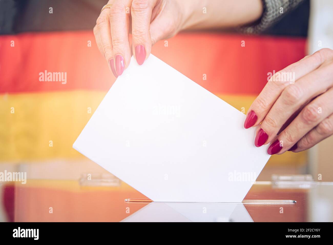 The hands of woman putting her vote in the ballot box Stock Photo - Alamy