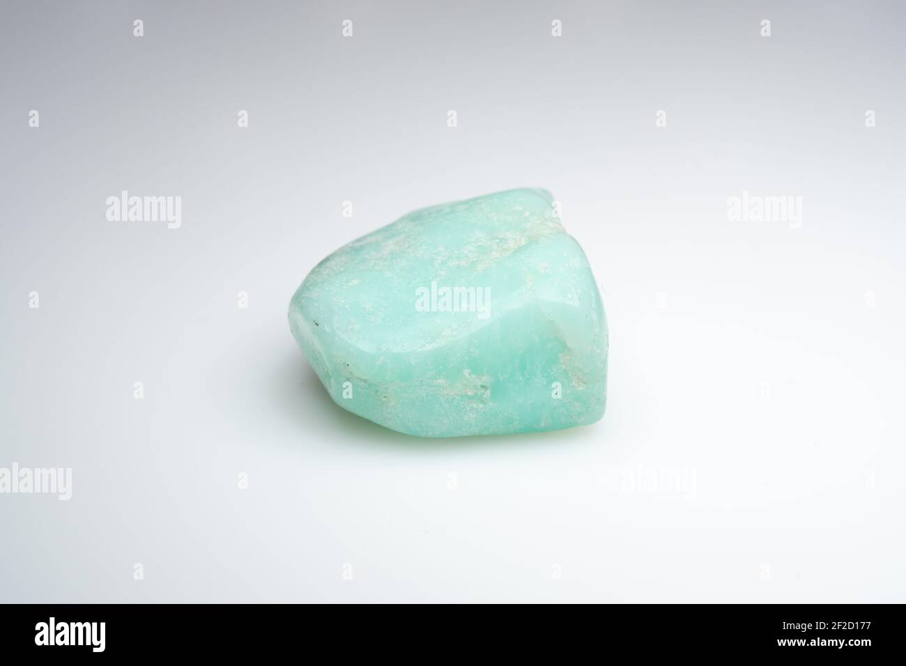Natural chrysoprase stone on a white background Stock Photo - Alamy