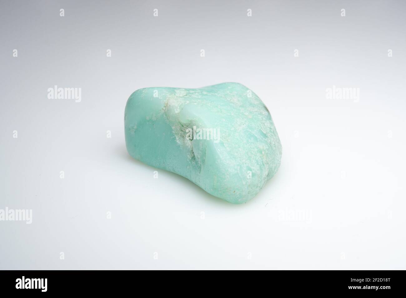 Natural chrysoprase stone on a white background Stock Photo - Alamy