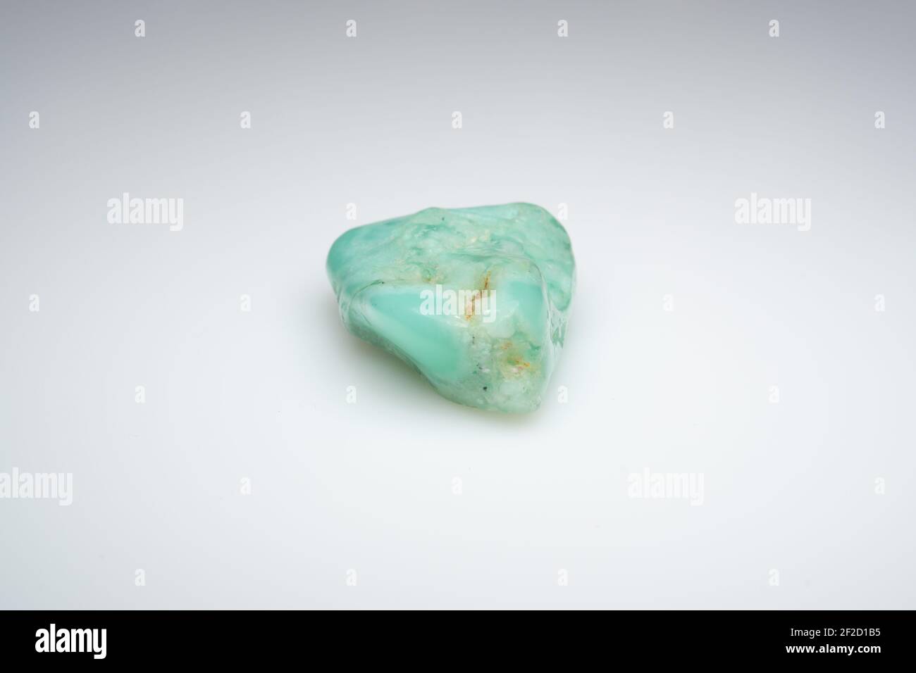 Natural chrysoprase stone on a white background Stock Photo - Alamy