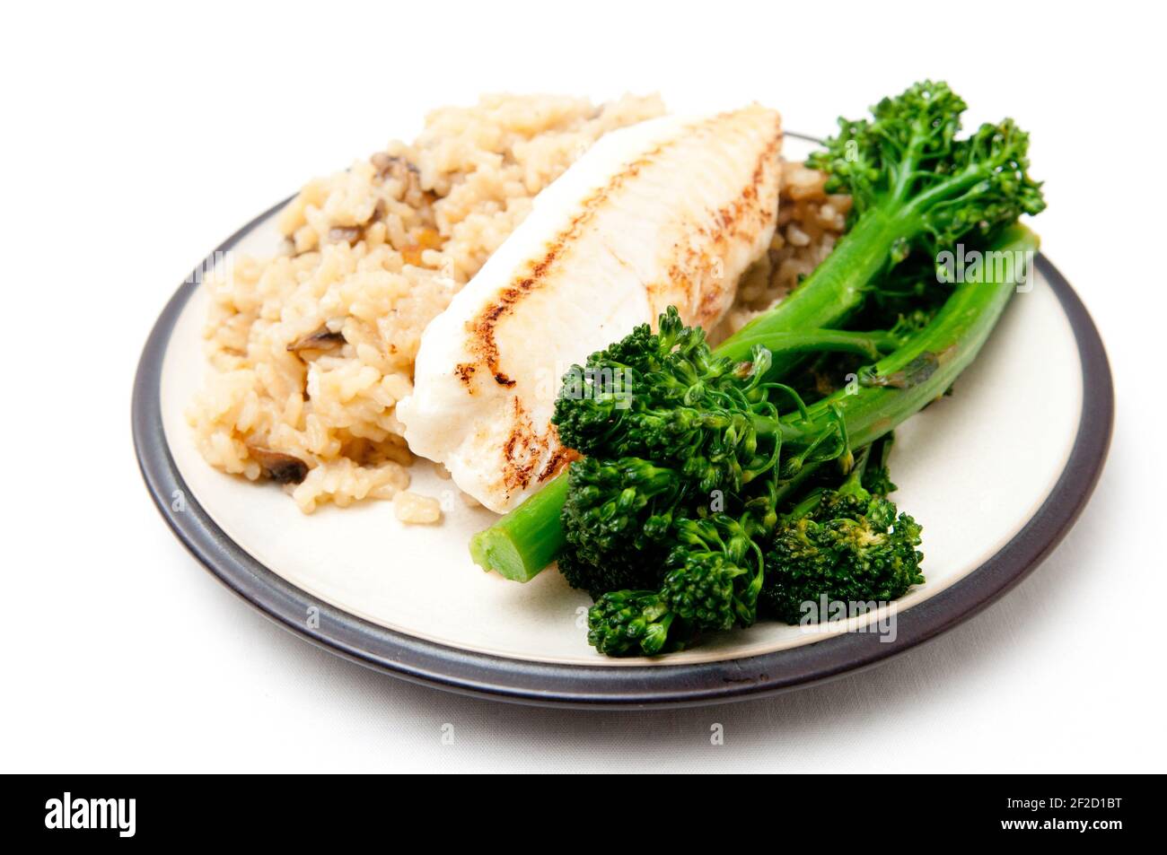 A fish fillet served with brown rice and broccolini Stock Photo - Alamy