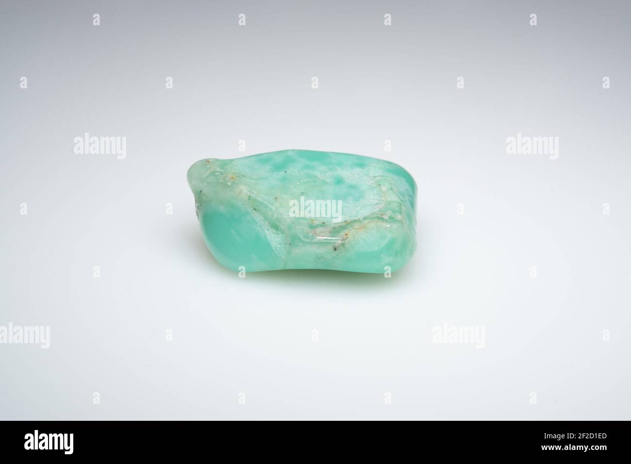 Natural chrysoprase stone on a white background Stock Photo - Alamy