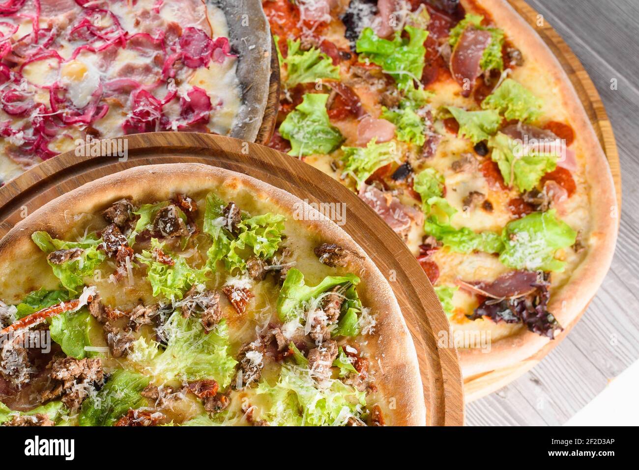 Assortment of pizzas with meat, salami, prosciutto, tomatoes ...
