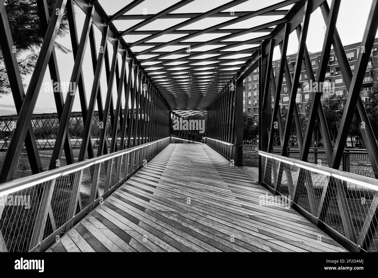 Bridge with railings formed by interlocking metal bars forming a ...