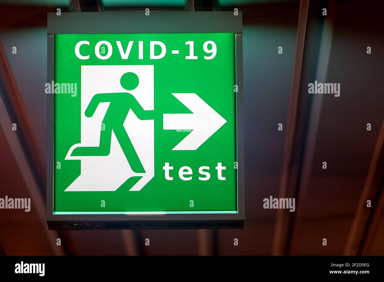 The emergency exit sign indicates the direction of path for rapid ...