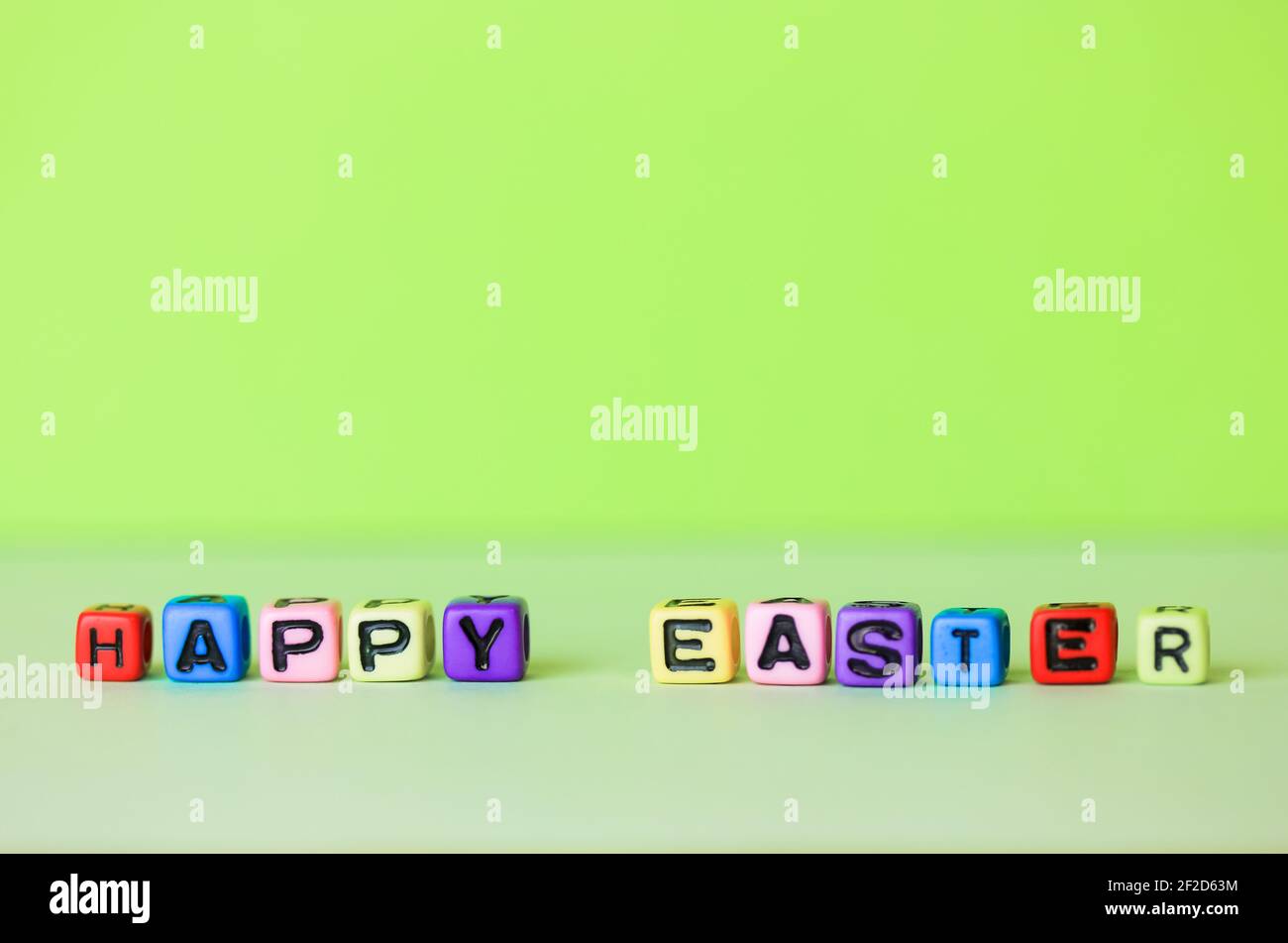 Happy Easter words written in multicolored wooden alphabet letters on a ...
