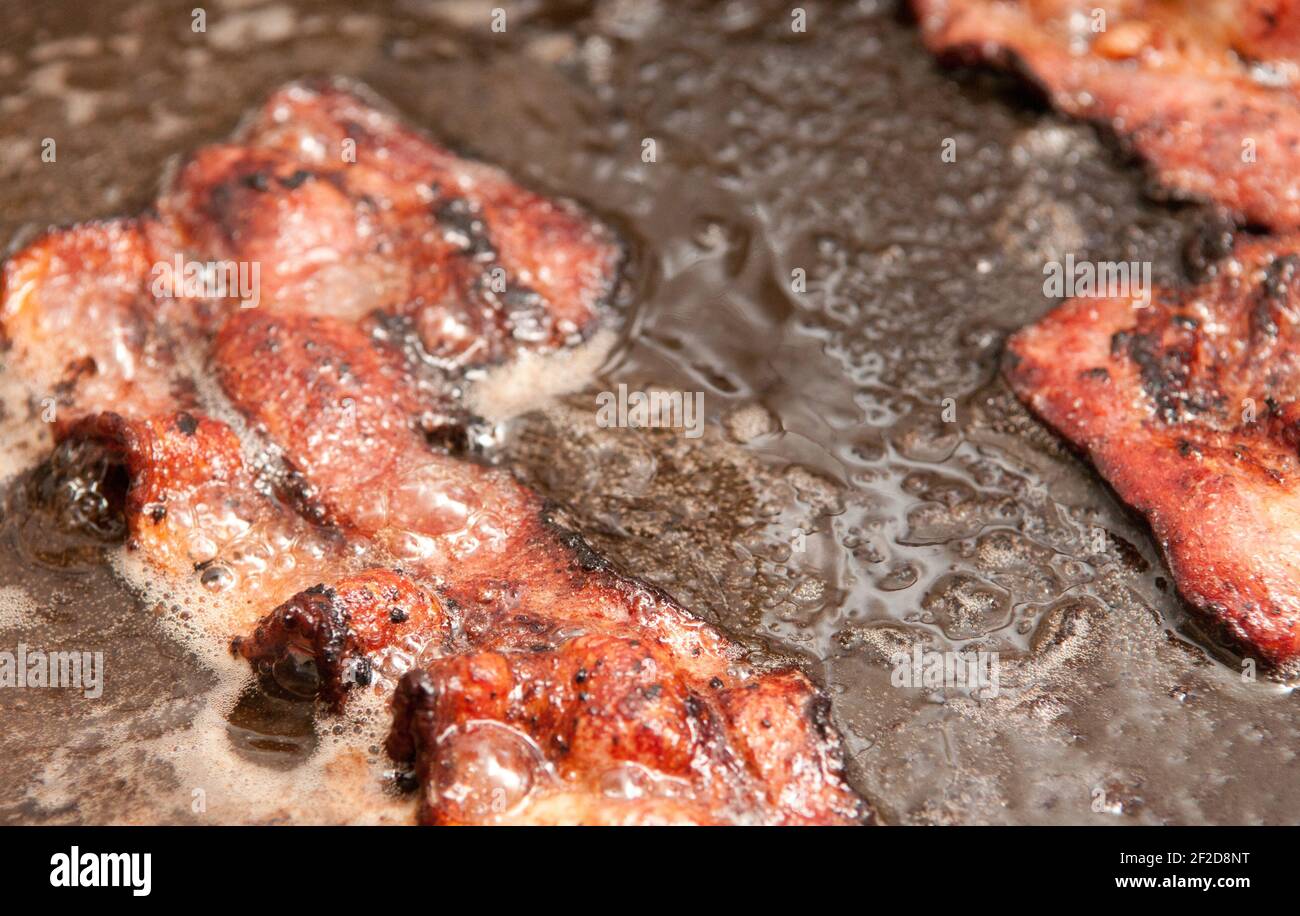 The roasted beacon pieces in the oil Stock Photo - Alamy