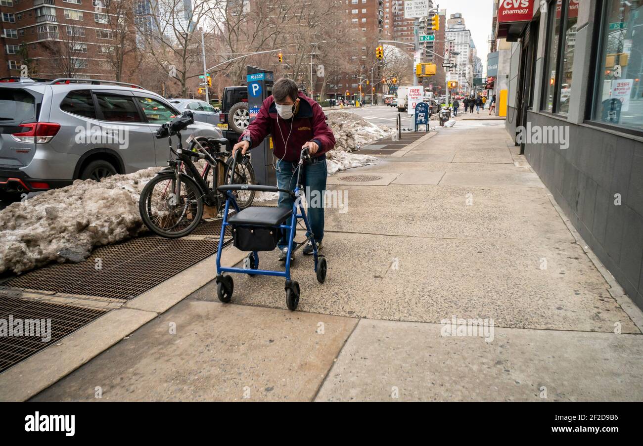 Elderly man with his walker in Chelsea in New York on Tuesday, February ...