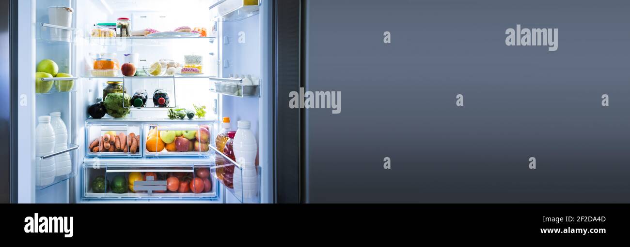 Full Open Refrigerator Or Fridge At Night In Kitchen Stock Photo - Alamy