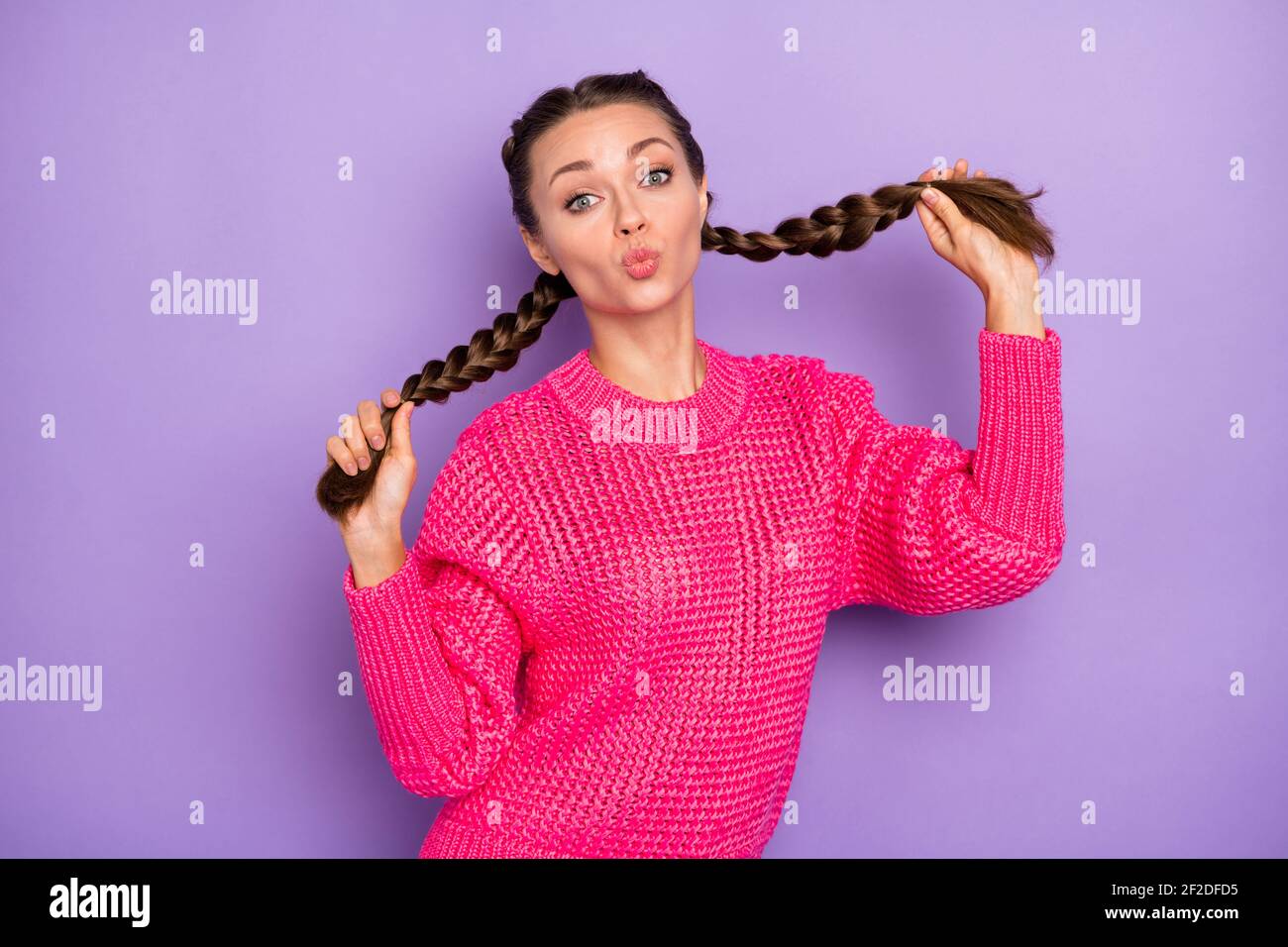 Photo of flirty cheerful young woman hold brunette hair braids send air ...