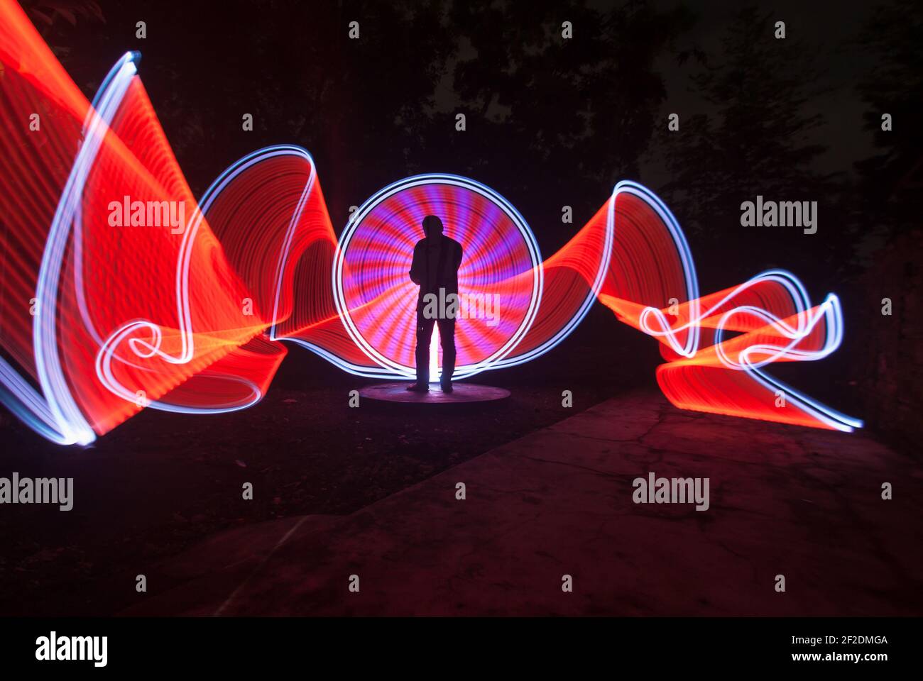 One person standing alone against beautiful color circle LED light ...