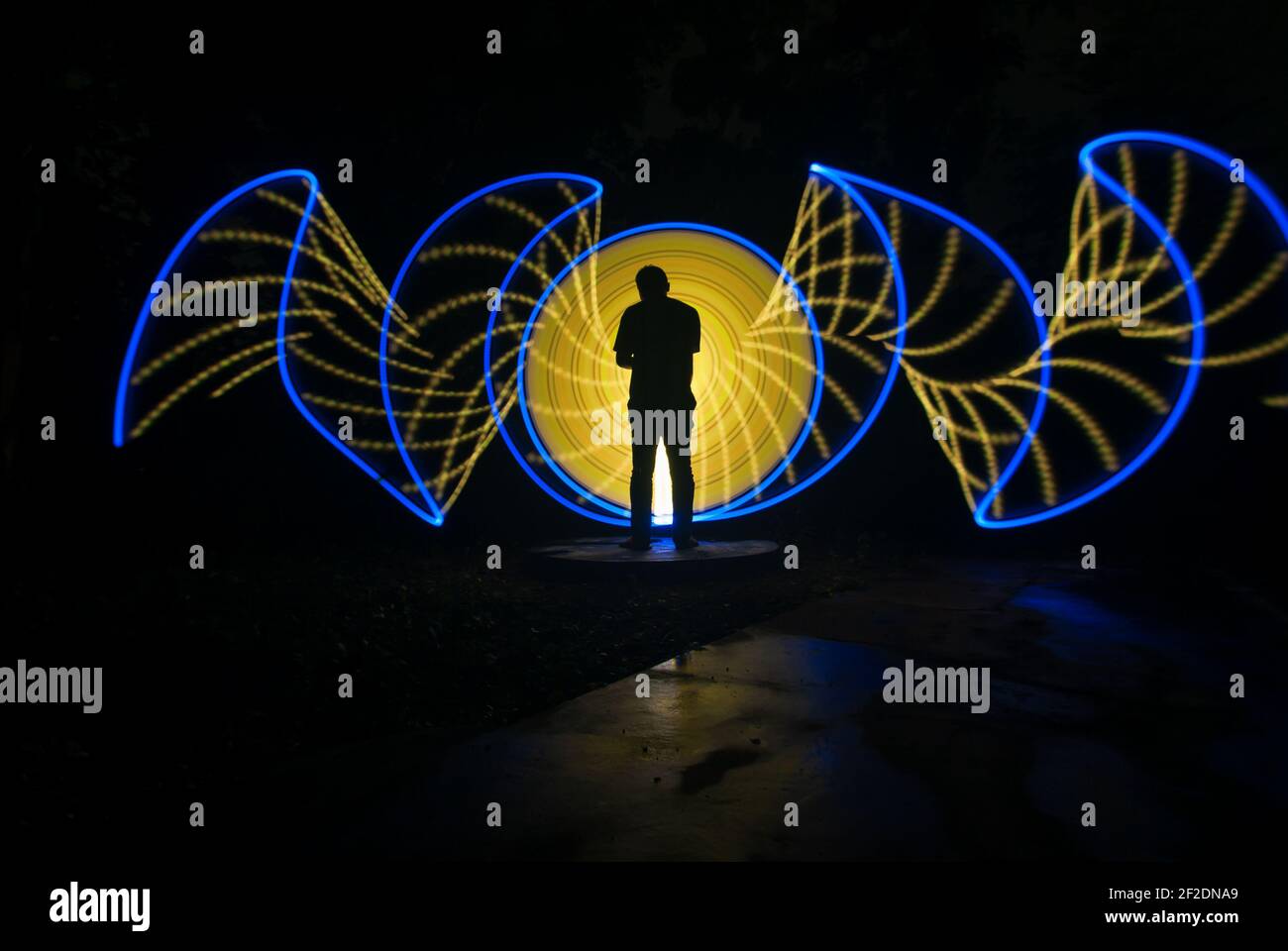 One person standing alone against beautiful color circle LED light ...