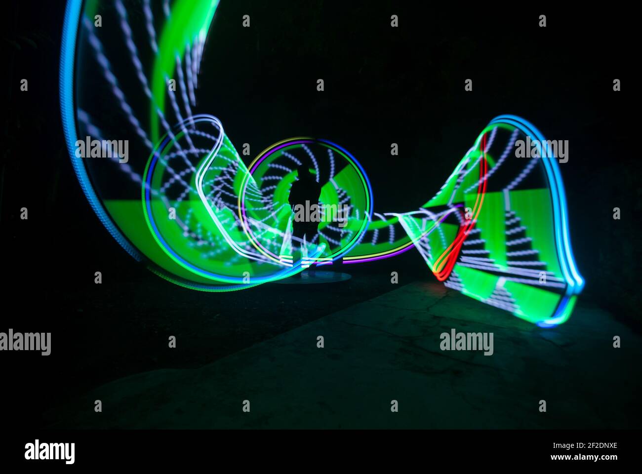 One person standing alone against beautiful color circle LED light ...