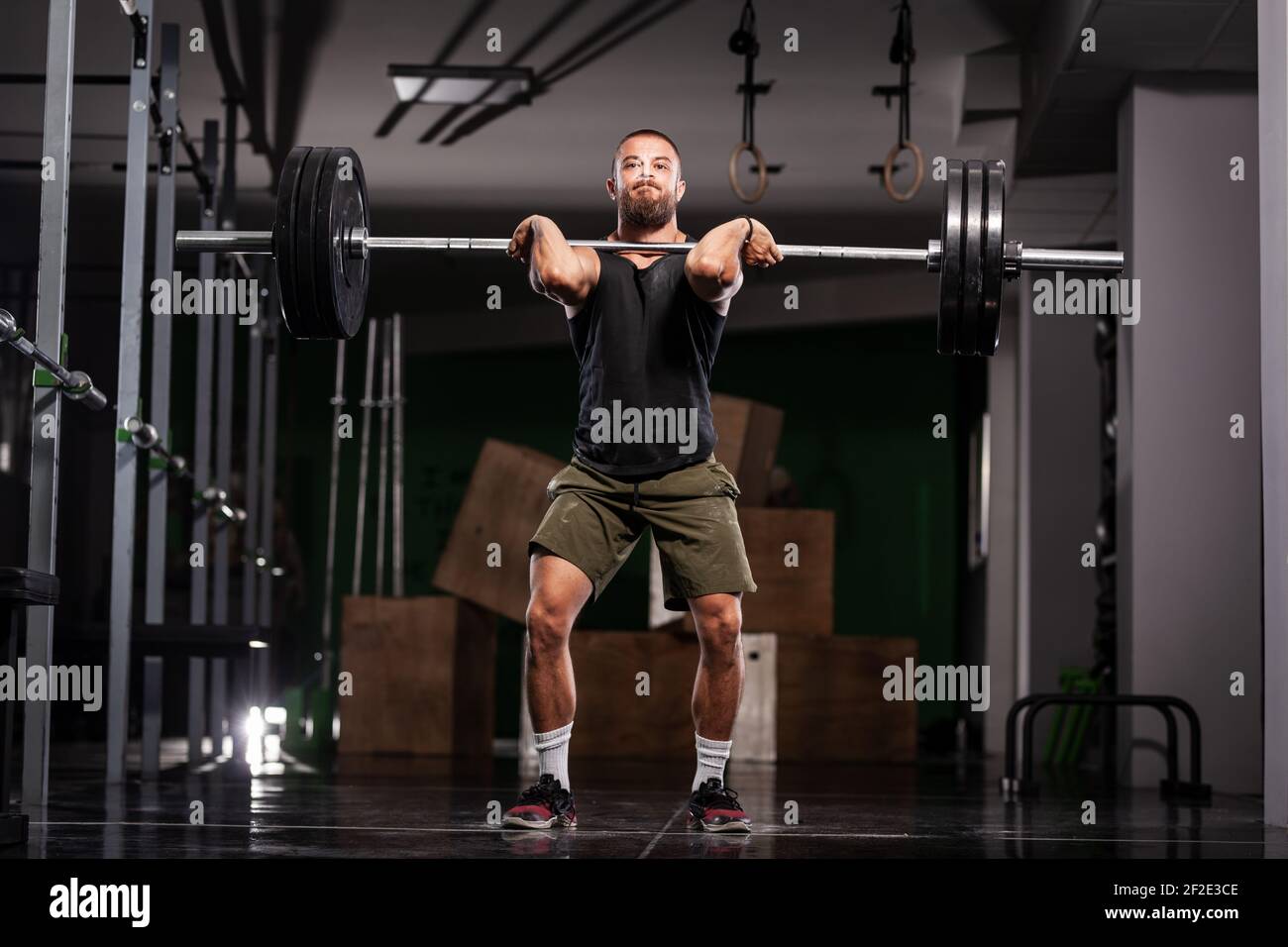 Muscular athlete lifting very heavy barbell Stock Photo - Alamy