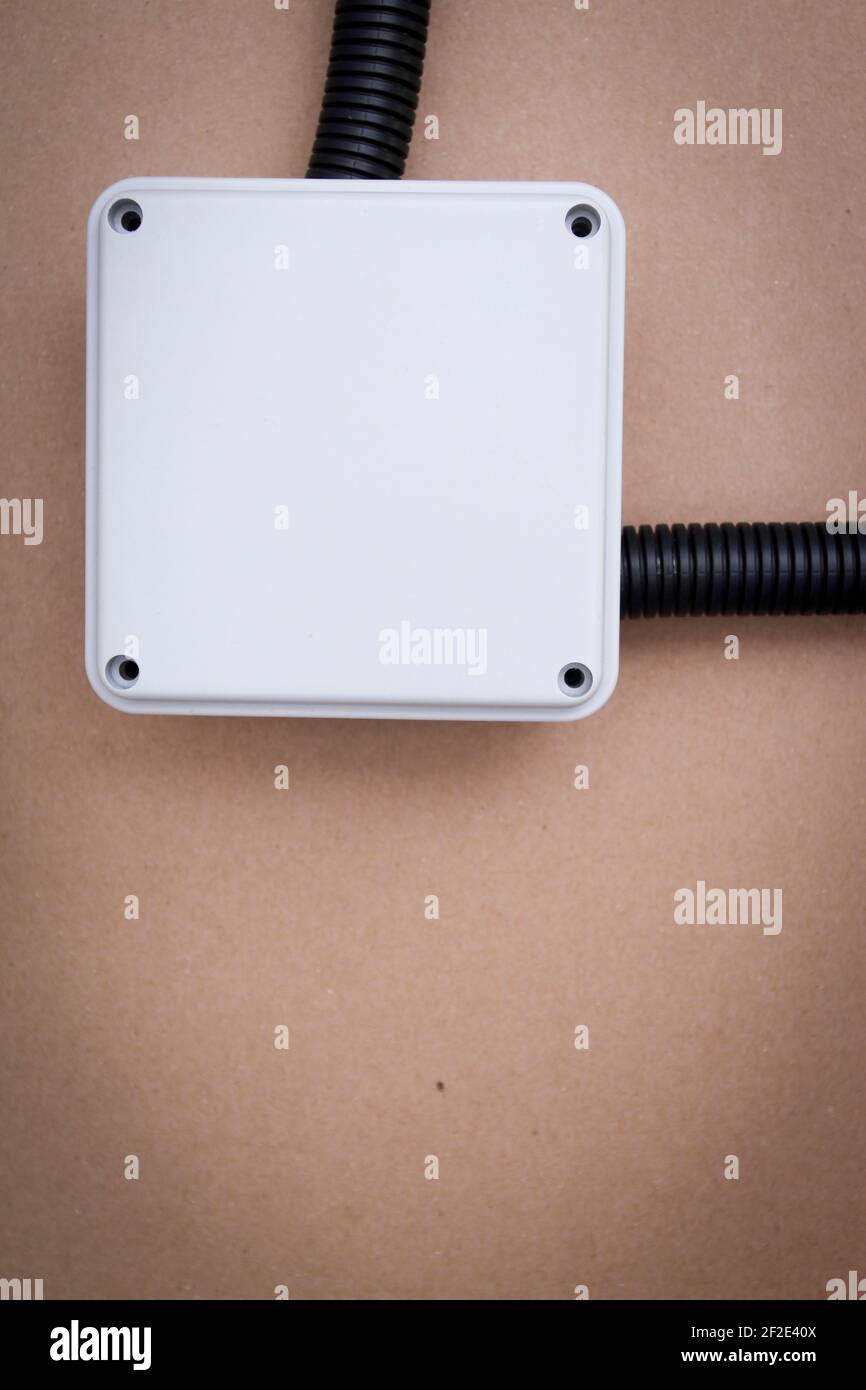 White electrical junction box with wires on beige background Stock ...
