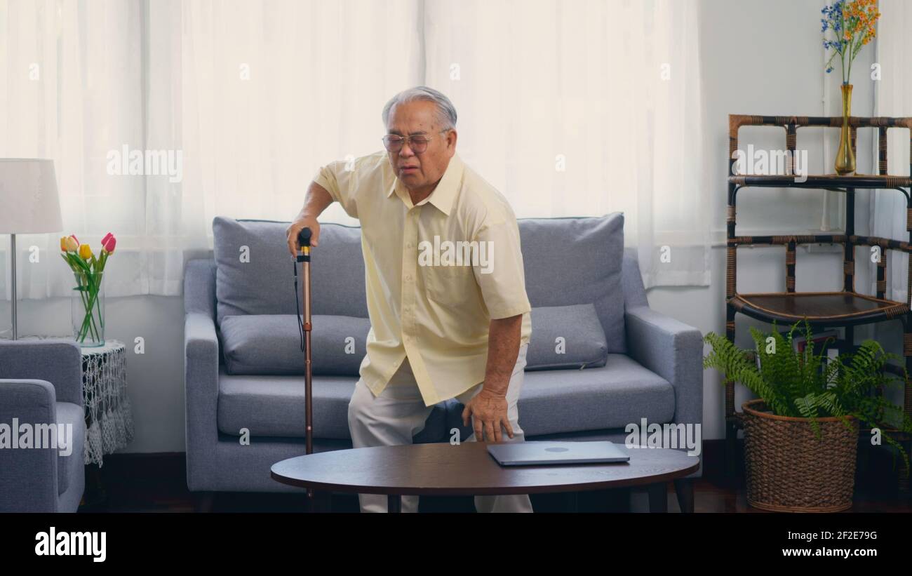 Old man grandfather with eyeglasses used a walking stick to lean the ...