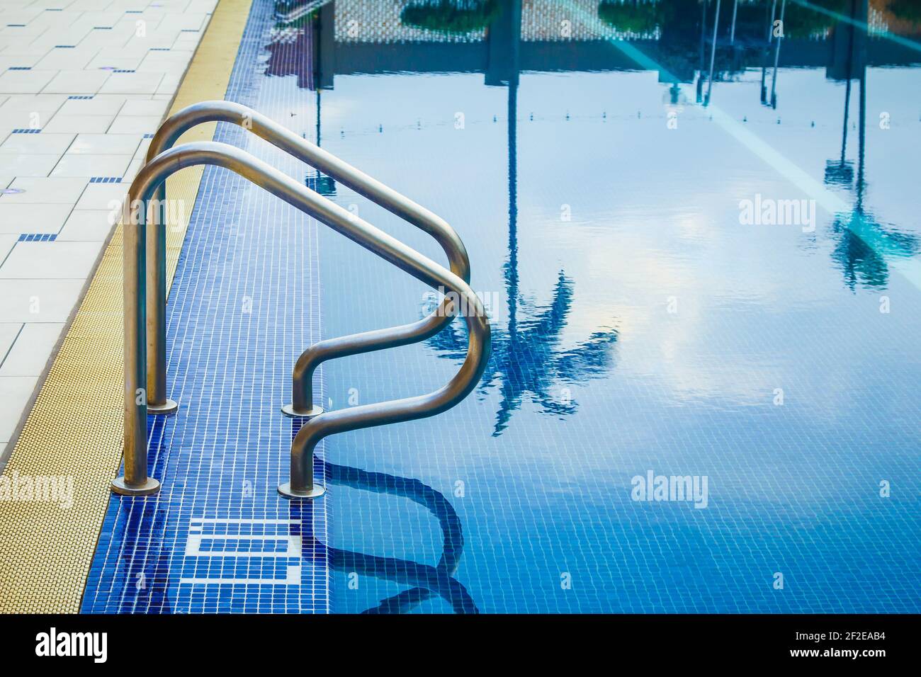 A swimming pool without people with metal handrails Stock Photo - Alamy