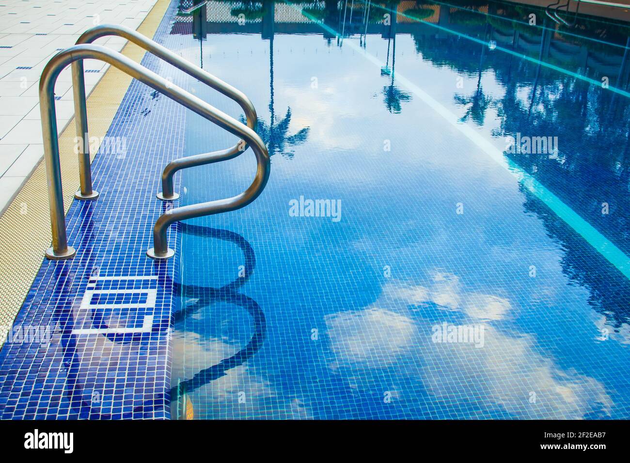 A swimming pool without people with metal handrails Stock Photo - Alamy