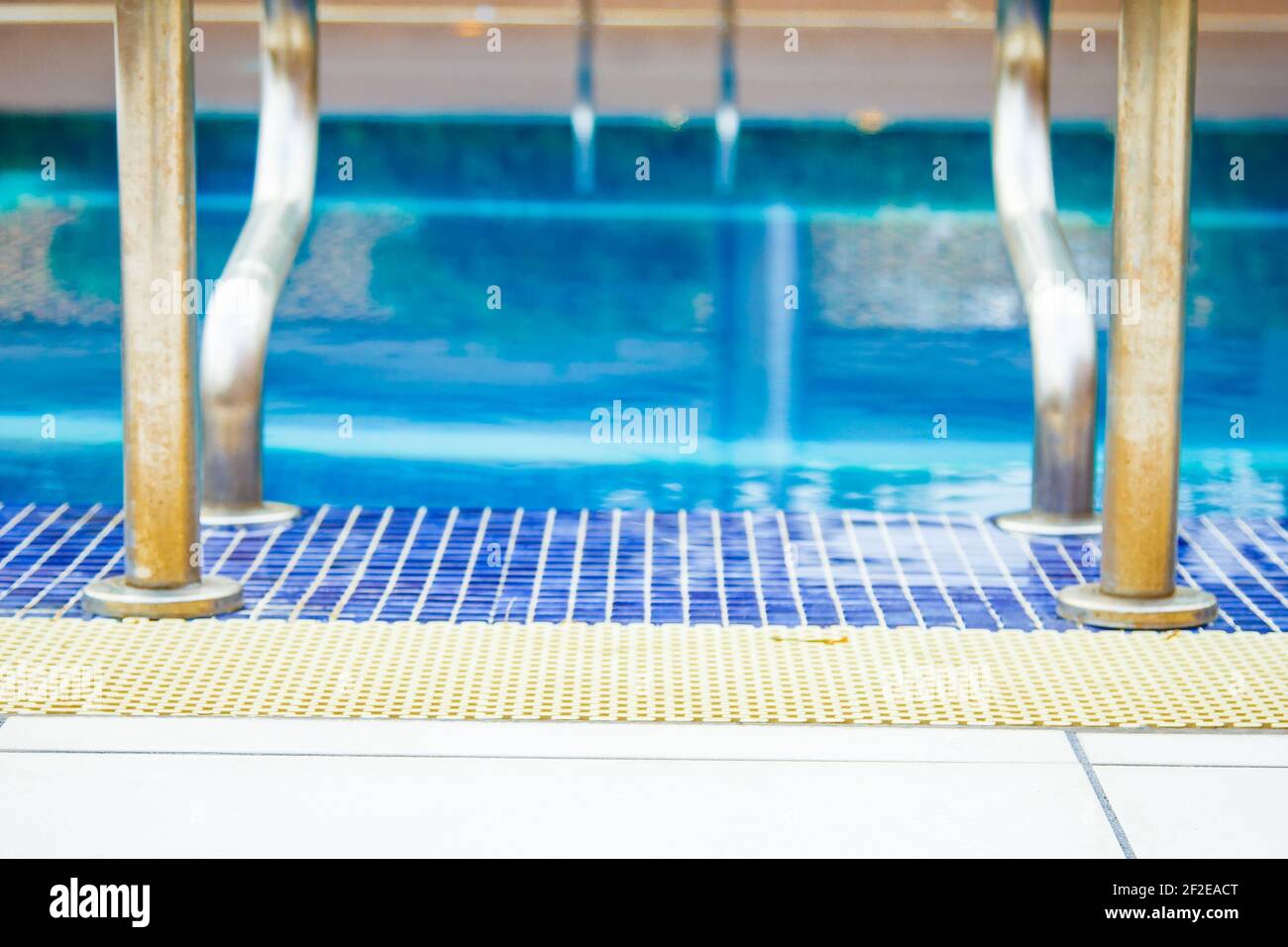 A swimming pool without people with metal handrails Stock Photo - Alamy