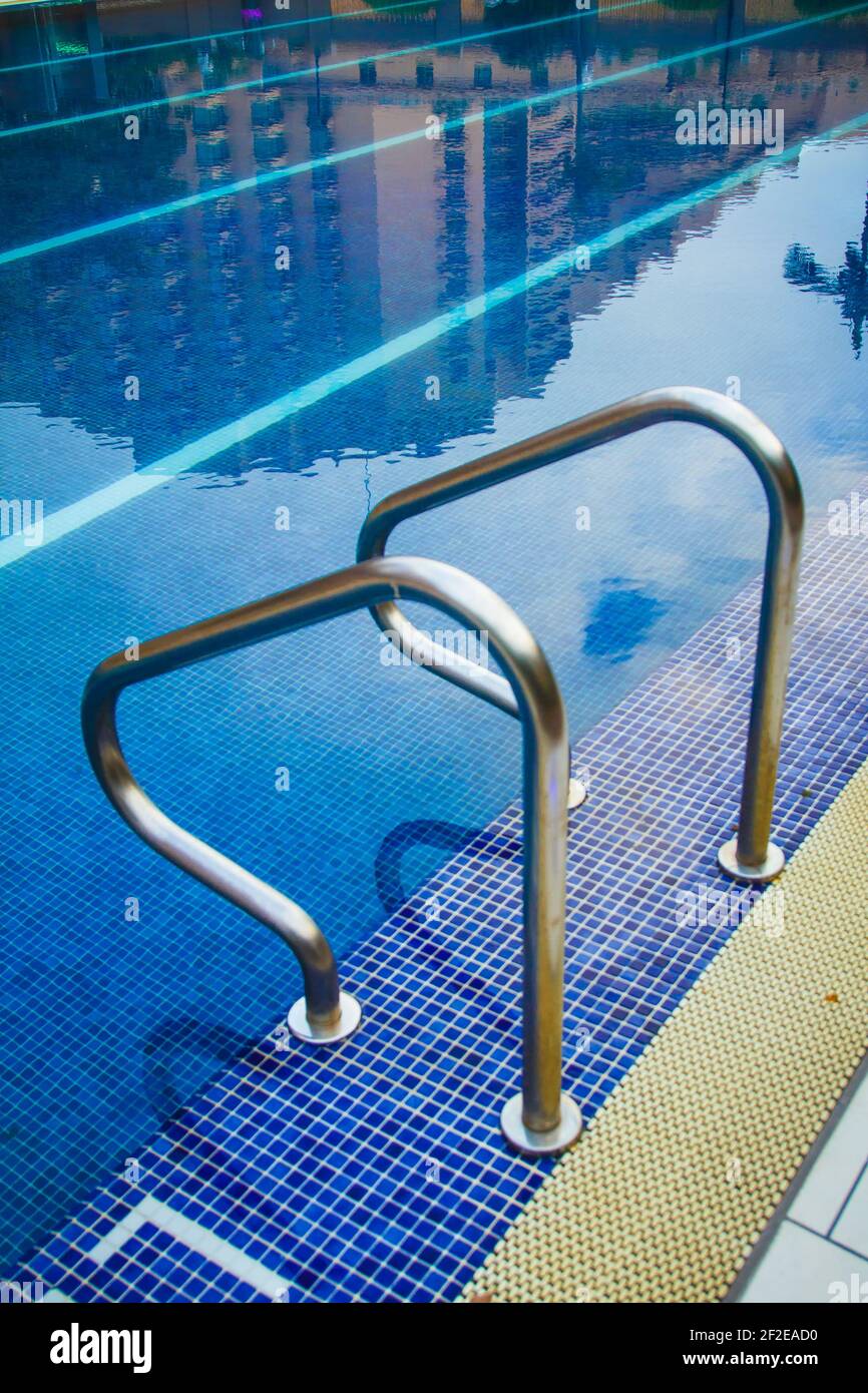 A swimming pool without people with metal handrails Stock Photo - Alamy