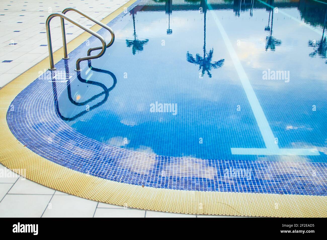 A swimming pool without people with metal handrails Stock Photo - Alamy