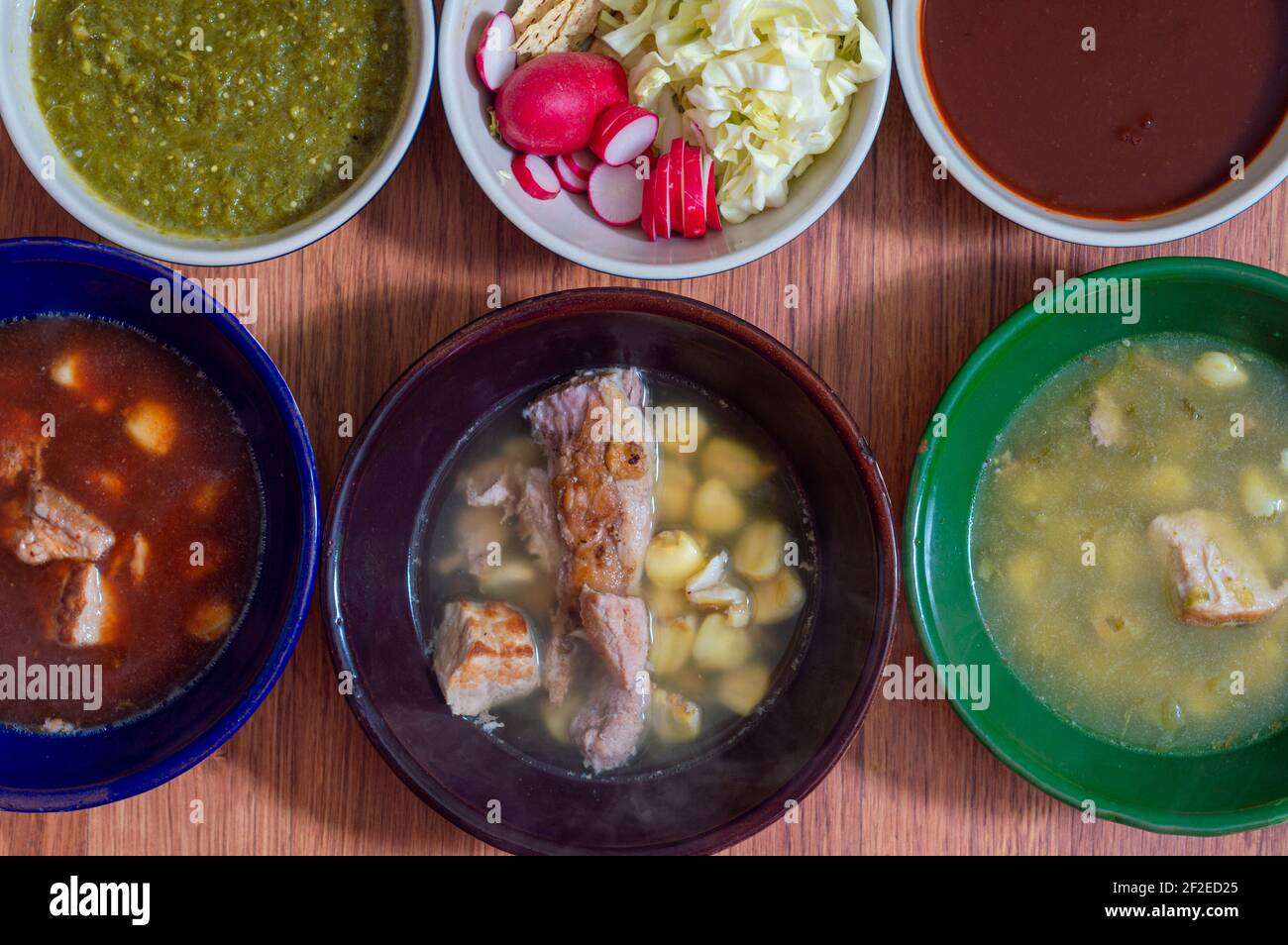 White, green and red pozole. Mexican pork and hominy corn stew Stock ...