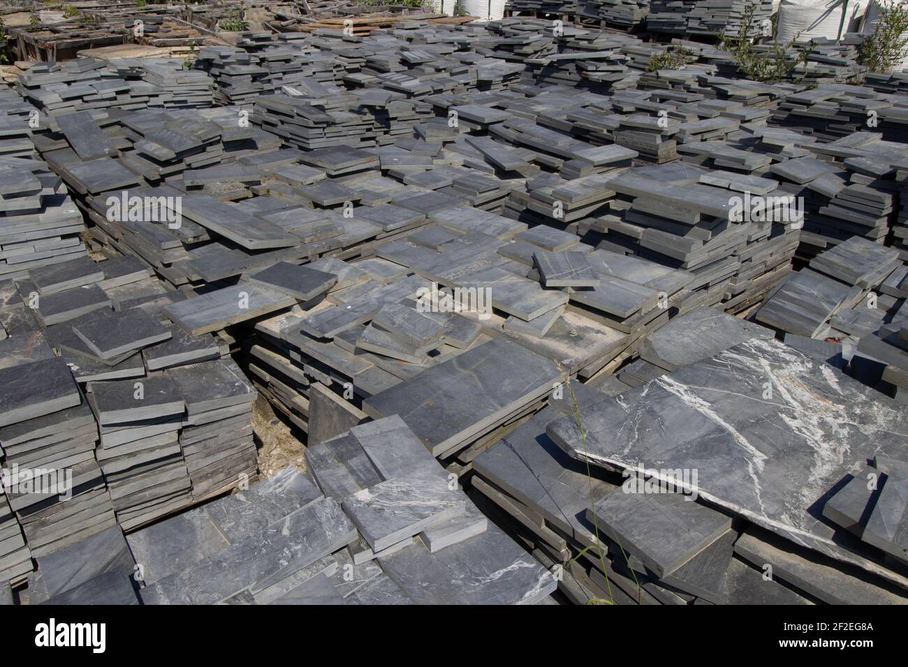raw slate piled neatly ready for cutting into roof tiles Stock Photo ...