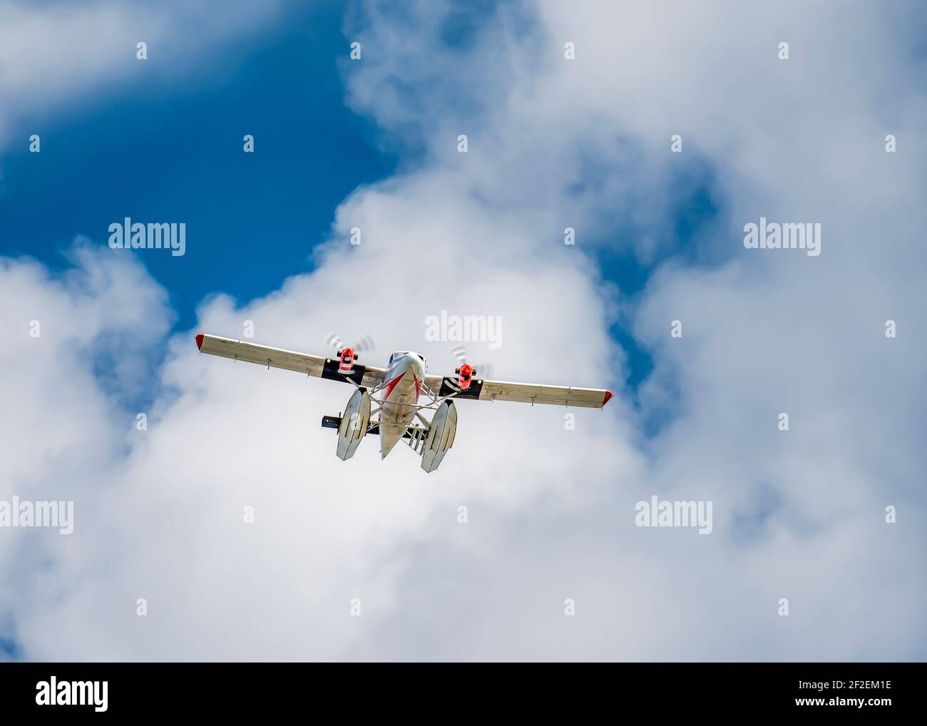 Light-engine propeller seaplane on the background of clouds Stock Photo ...