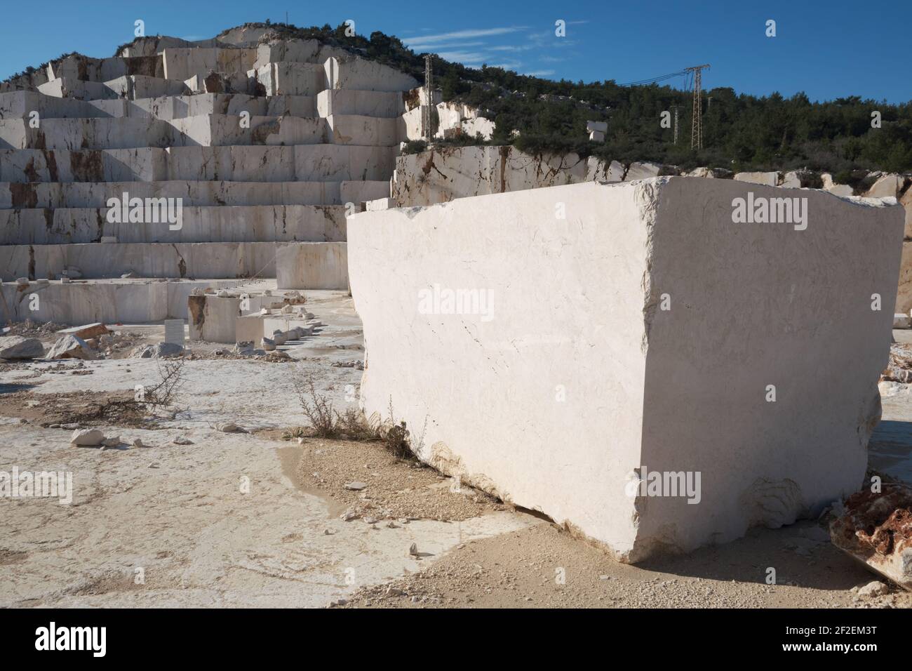 Marble block on foreground and quarry at background Stock Photo - Alamy