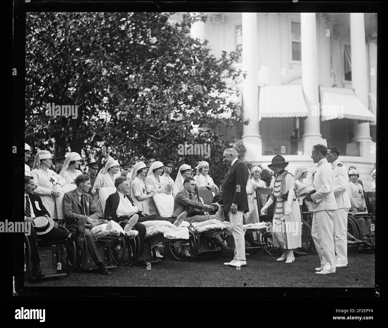 Pres. and Mrs. Harding shaking hands with veterans at White House ...