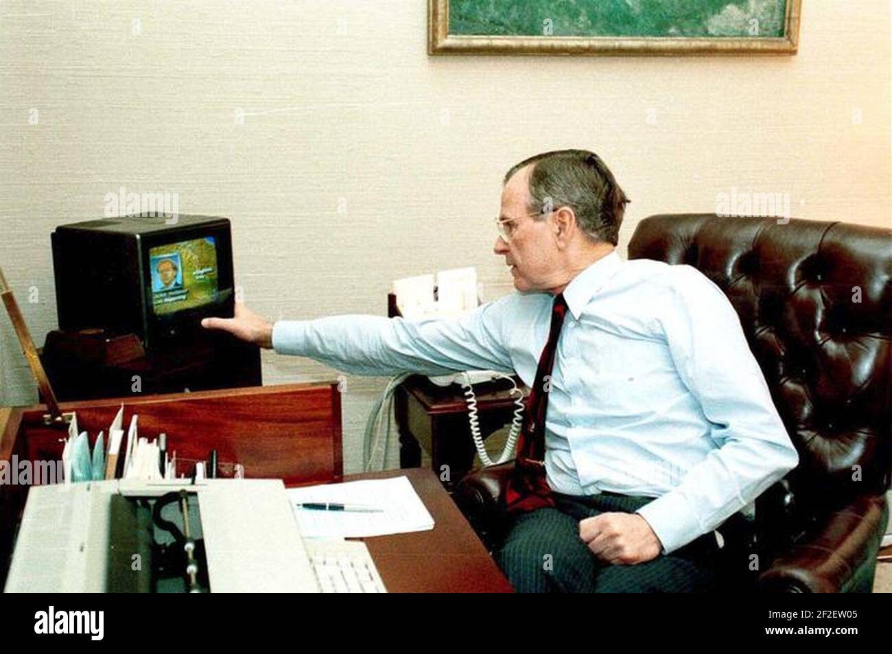 President George H. W. Bush watches TV coverage of the commencement of ...