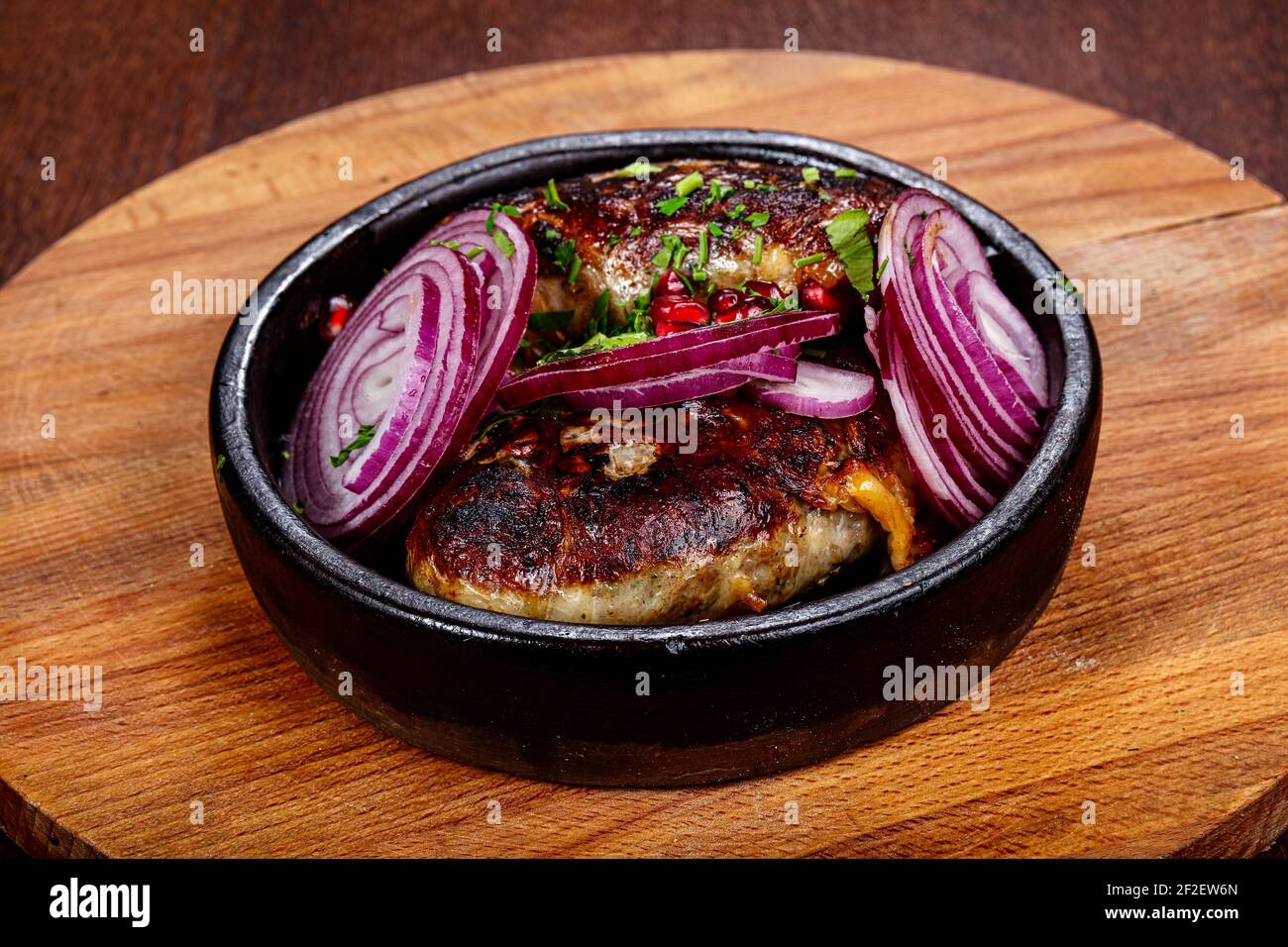 Roasted pork cutlet in the pot served onion Stock Photo - Alamy
