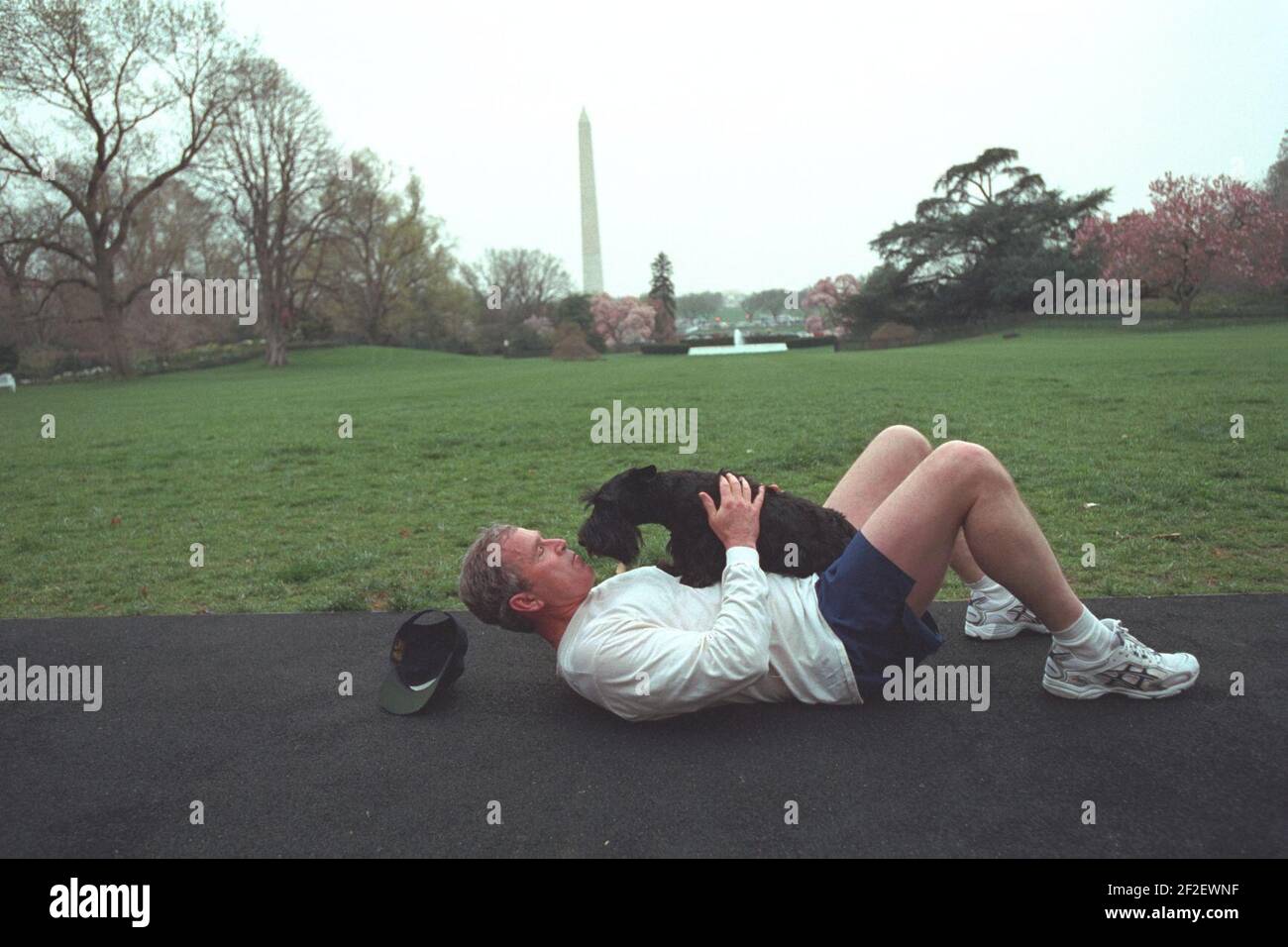 President George W. Bush Lies on the Track and Holds Barney on his ...