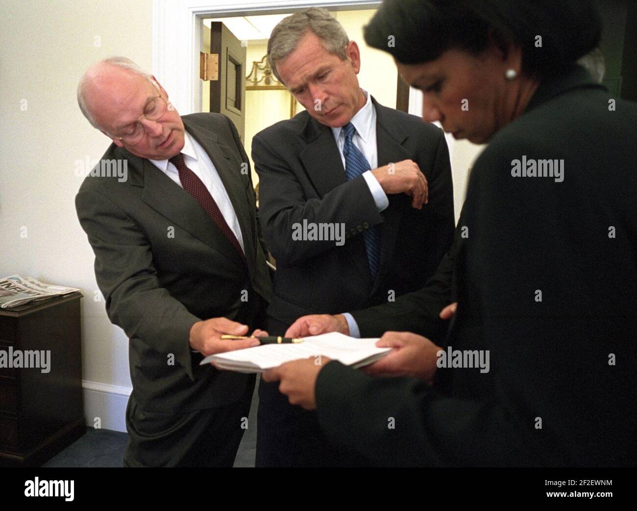 President George W. Bush looks over a brief with Vice President Dick ...