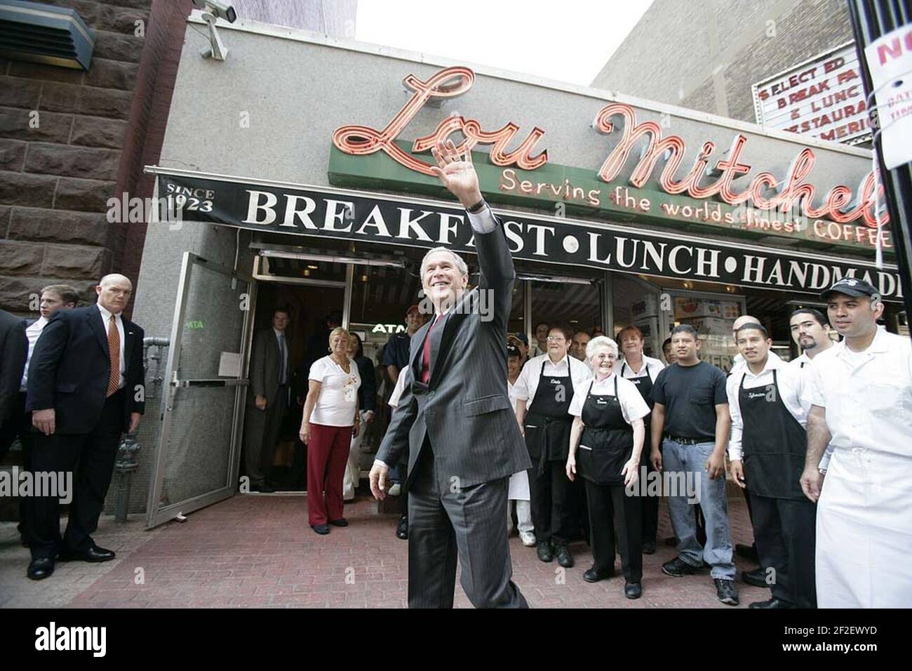 President George W. Bush waves as he leaves Lou Mitchell’s restaurant ...