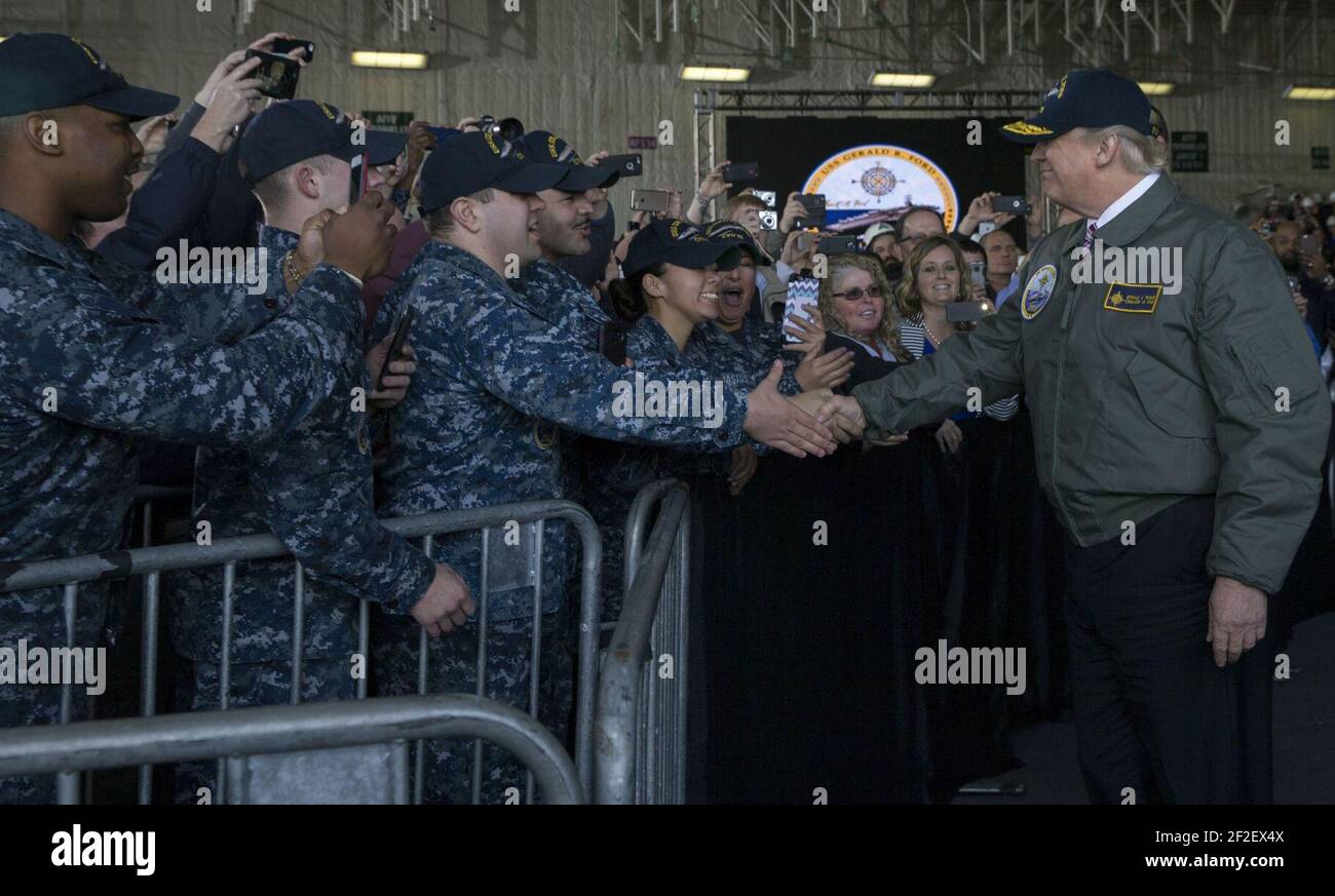President greets Sailors after entering the hangar bay of USS Gerald R ...