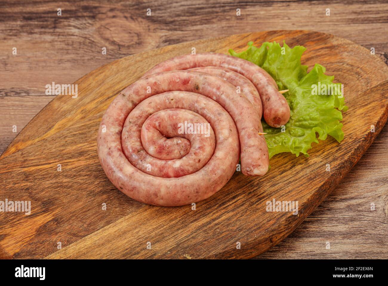 Raw pork sausage ring for grill Stock Photo - Alamy